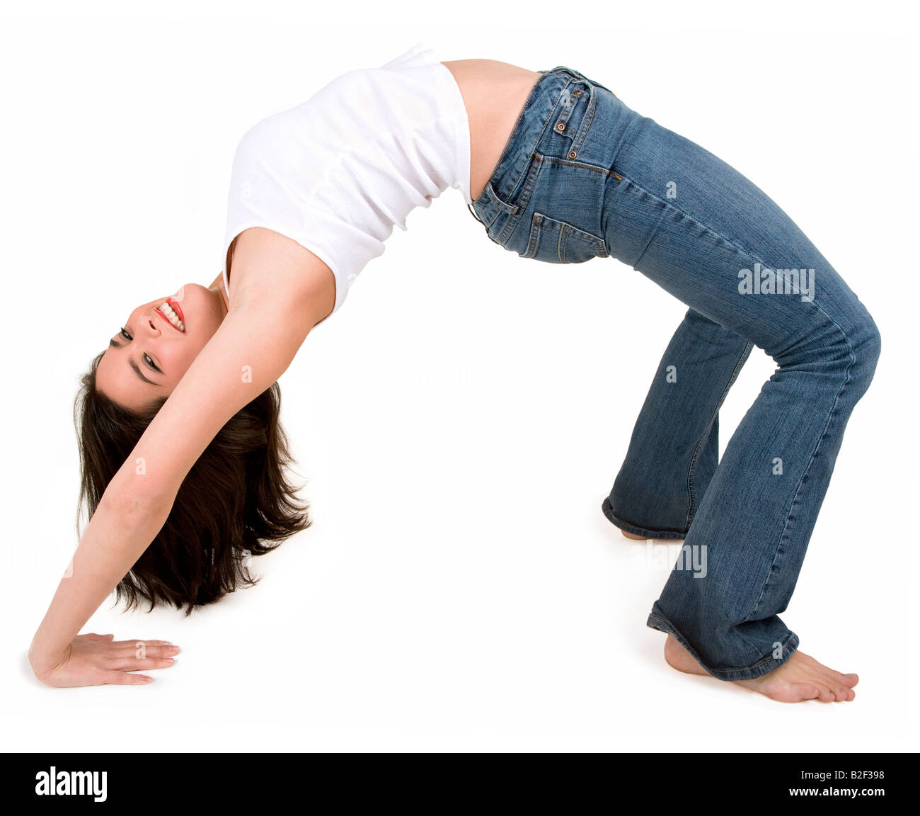 A young beautiful brunette is in bridge pose Stock Photo - Alamy