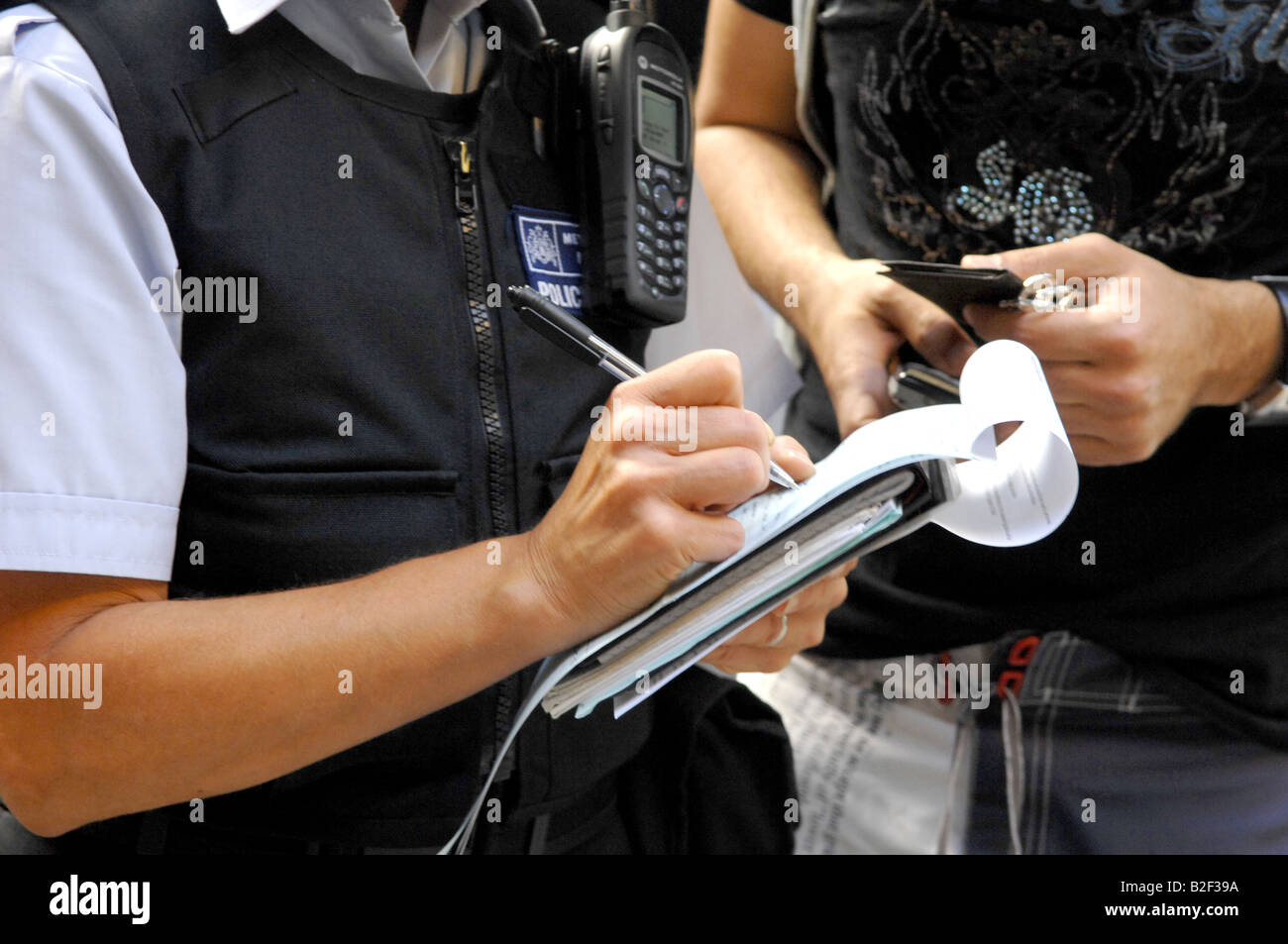police officer issuing stop and search Stock Photo - Alamy