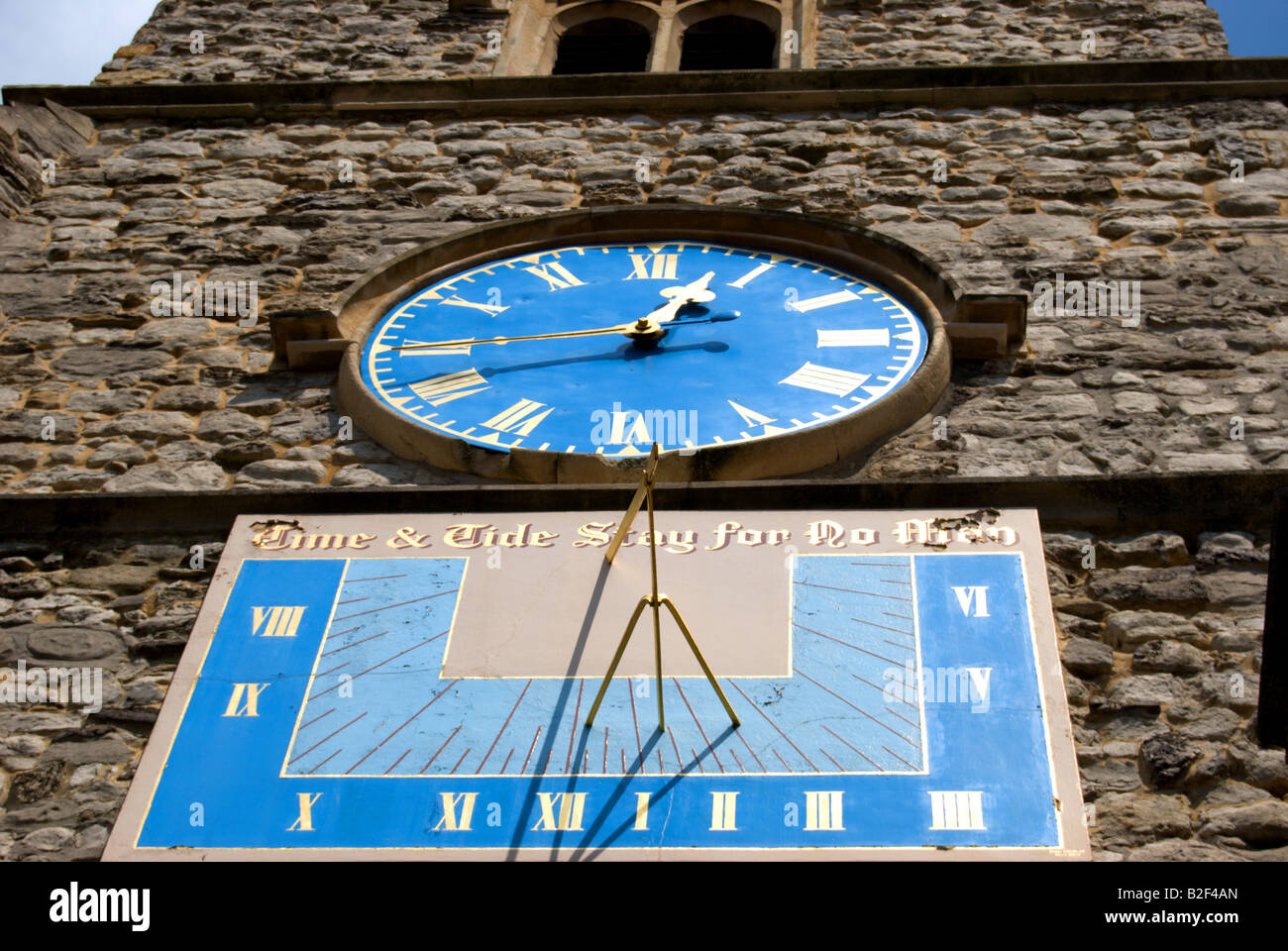 clock and sundial with biblical quotation on the tower of saint mary's ...