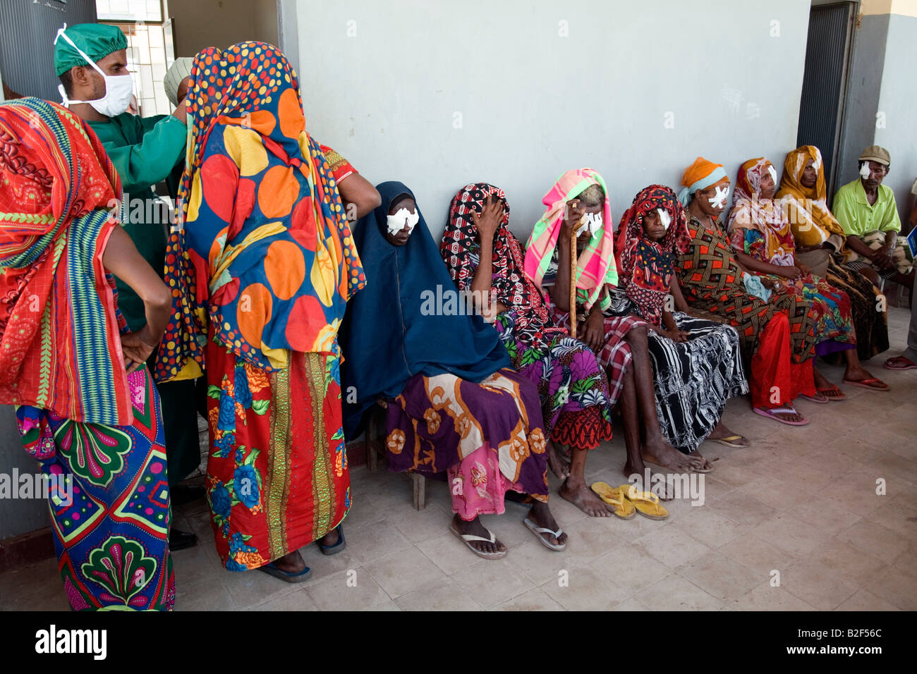 A medic examines villagers outside a rural government health clinic in ...