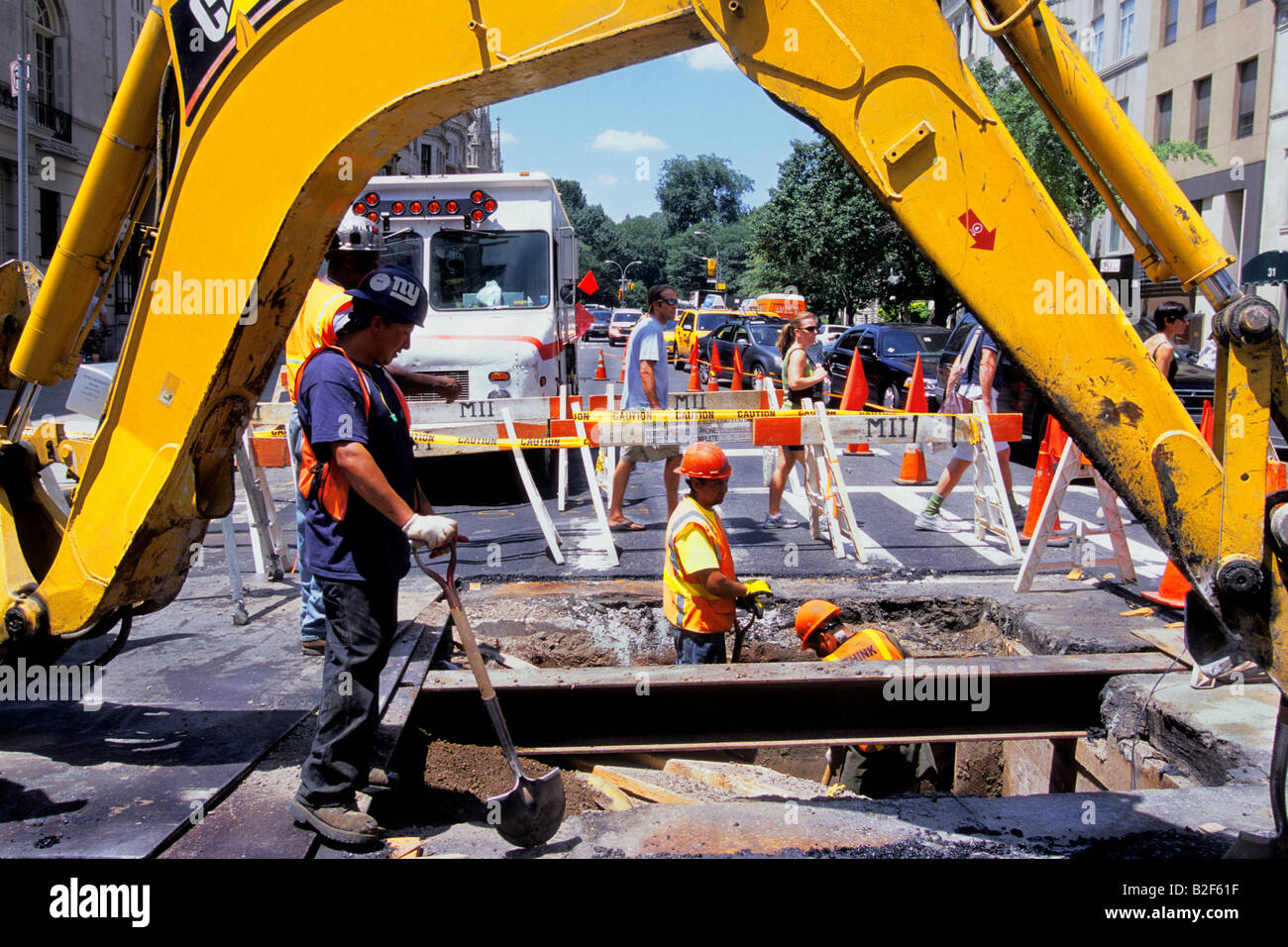 Infrastructure road repair work on the street of New York City. Hard ...