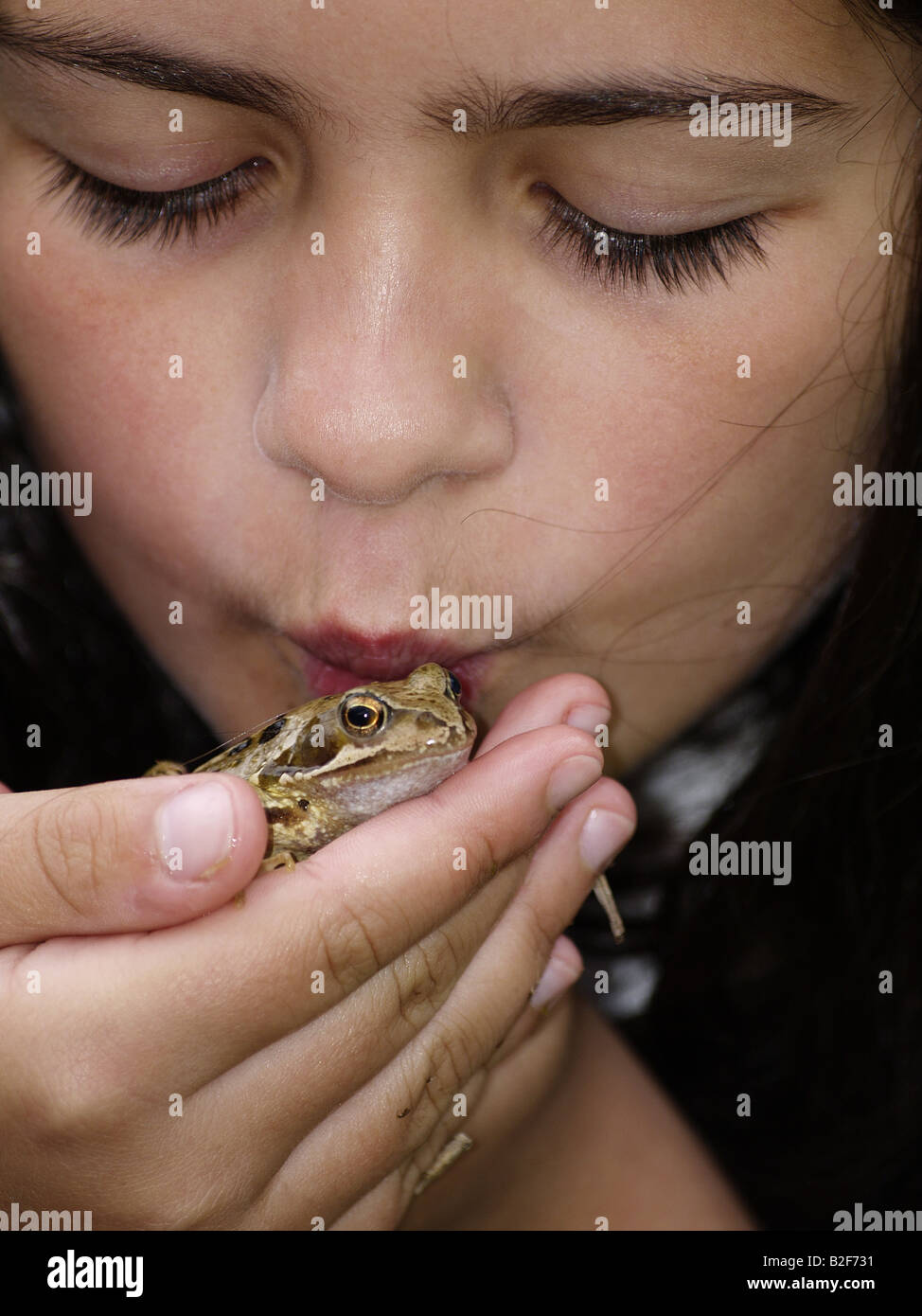 Young girl kissing a common frog Stock Photo - Alamy