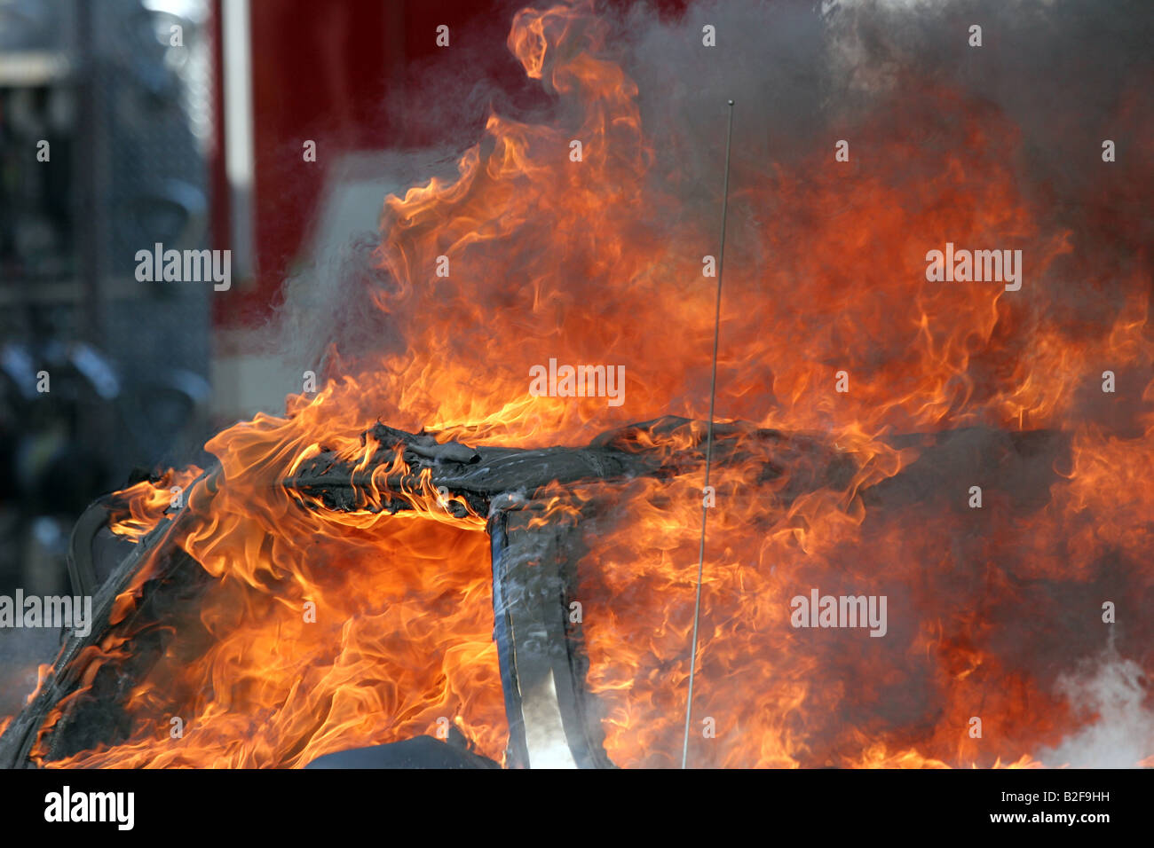 Firefighters on the scene of a car fire Stock Photo - Alamy