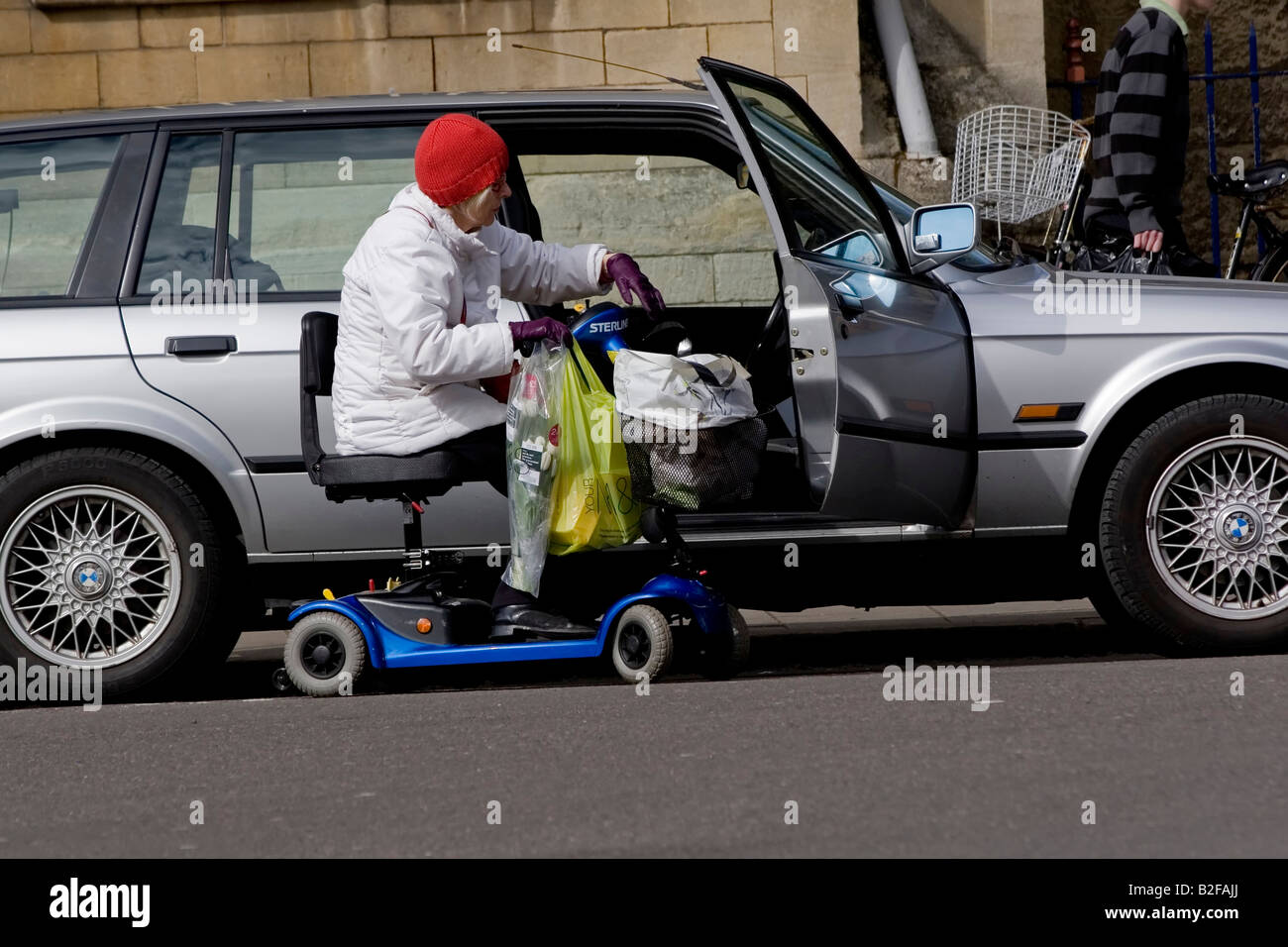 Senior woman in motorized chair getting into car Stock Photo - Alamy