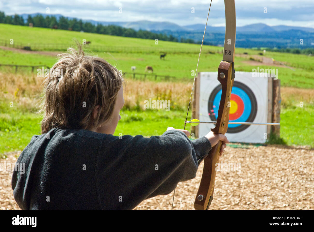 Boy at archery class at holiday centre Stock Photo - Alamy