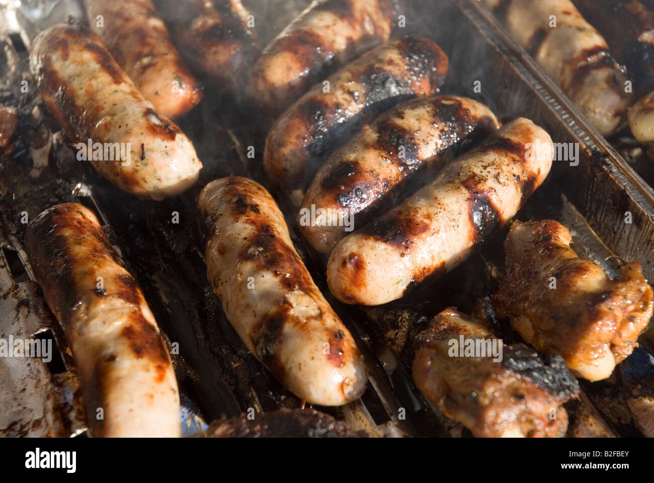 sausages cooking on a barbecue Stock Photo - Alamy
