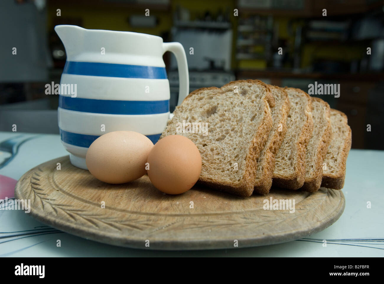 basic food stuffs on a breadboard in a domestic kitchen Stock Photo - Alamy