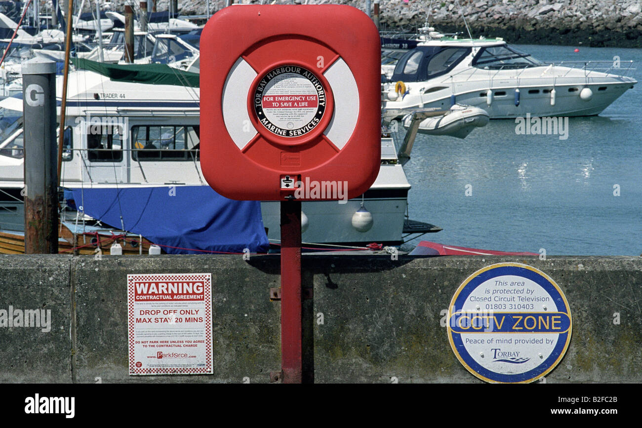 Signs along the harbour side in Brixham Devon England Stock Photo - Alamy