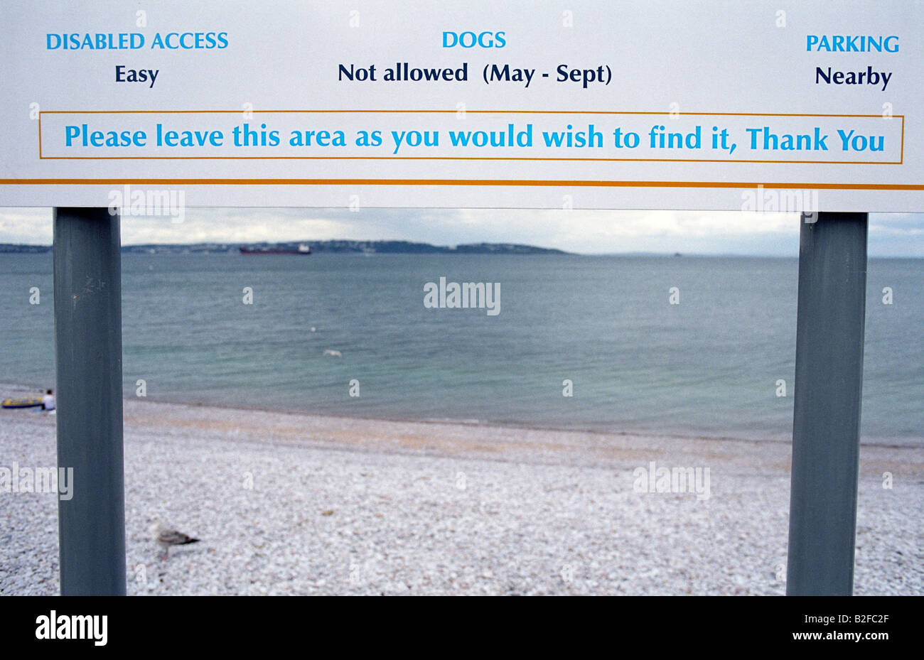 Sign next to a beach in Brixham Devon England Stock Photo - Alamy