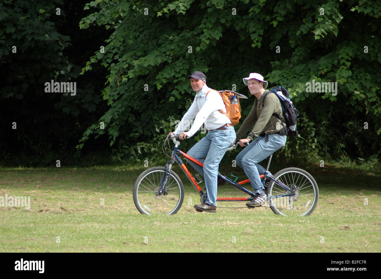 Two men riding tandem bicycle hi-res stock photography and images - Alamy