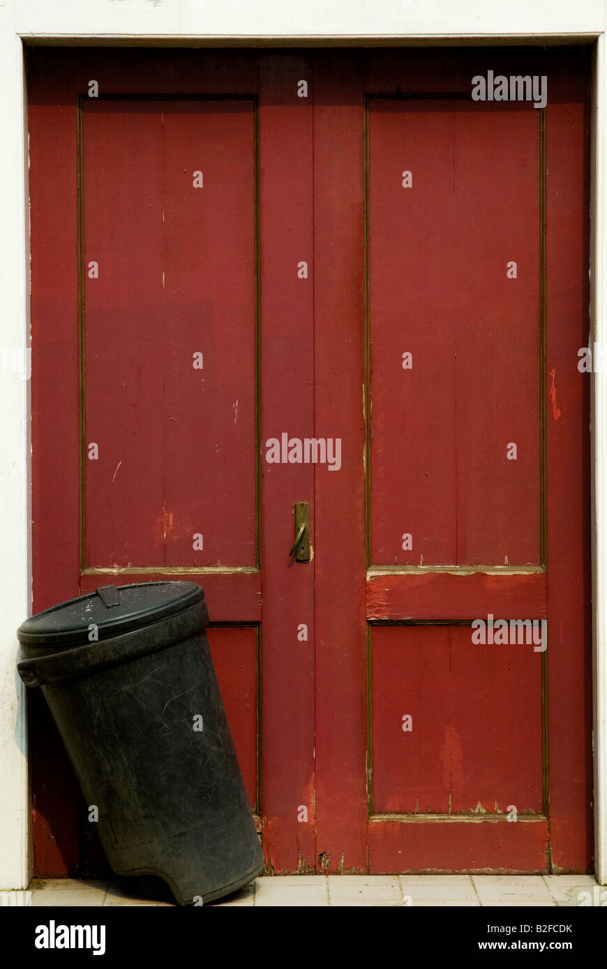 red door with the garbage can Stock Photo - Alamy