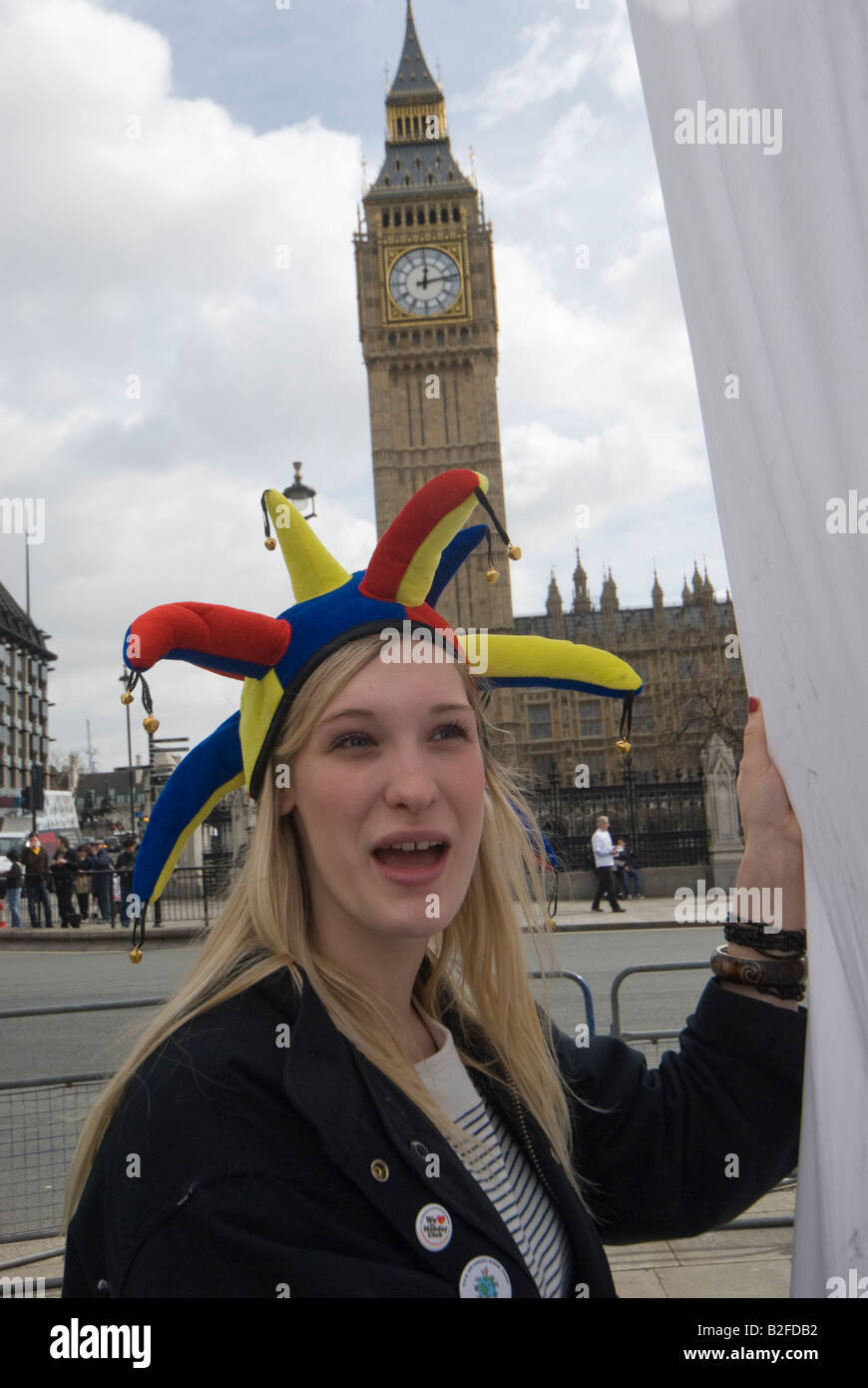 Young woman in jesters cap and Big Ben in Parliament Square 'Fossil ...