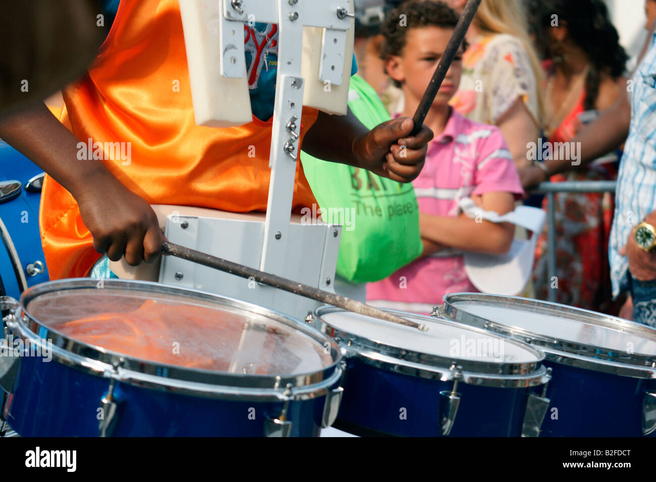 Young black drumming drummers musicians with drums outdoors playing at ...