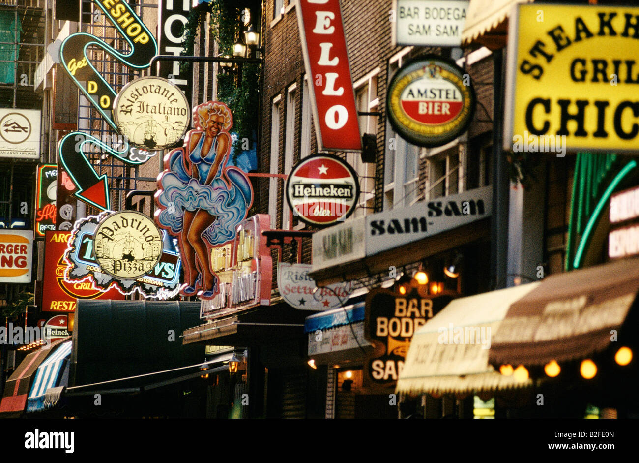 Signs of bars and restaurants in a tourist area of Amsterdam, Holland ...