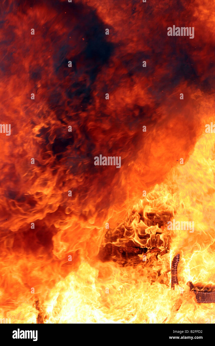 A room on fire with a charred chair in the lower right Stock Photo - Alamy