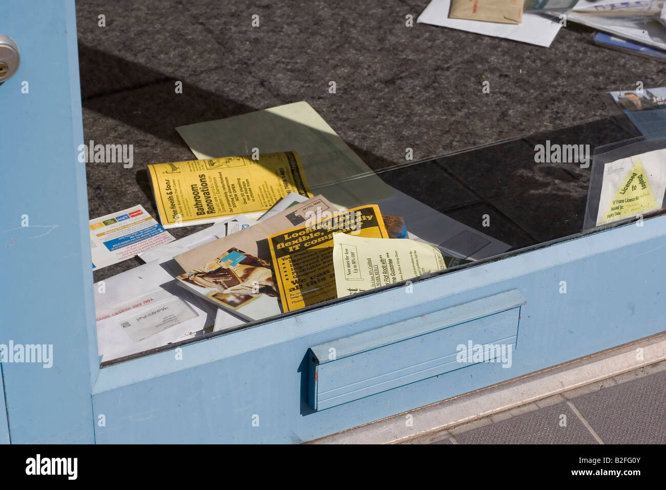 Close-up of mailbox slot and junk mail Stock Photo - Alamy
