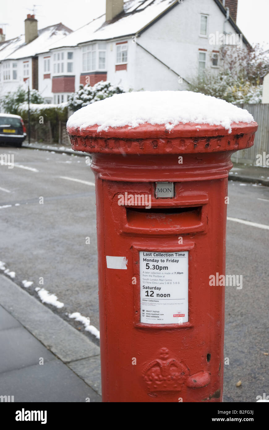 The top of a red letterbox is coered in snow in Wandsworth, London, UK ...