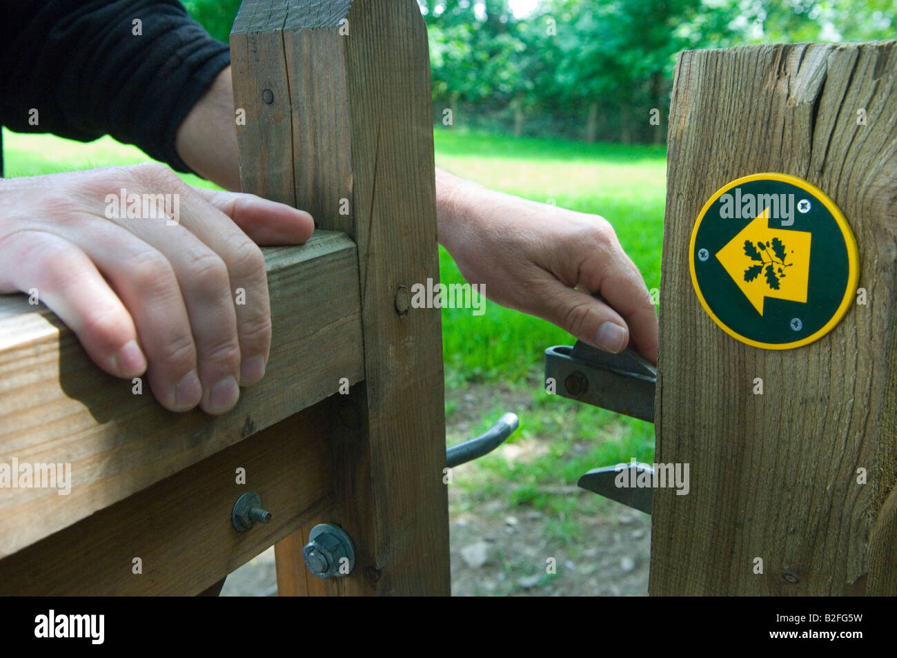 Hands opening a footpath gate Stock Photo - Alamy