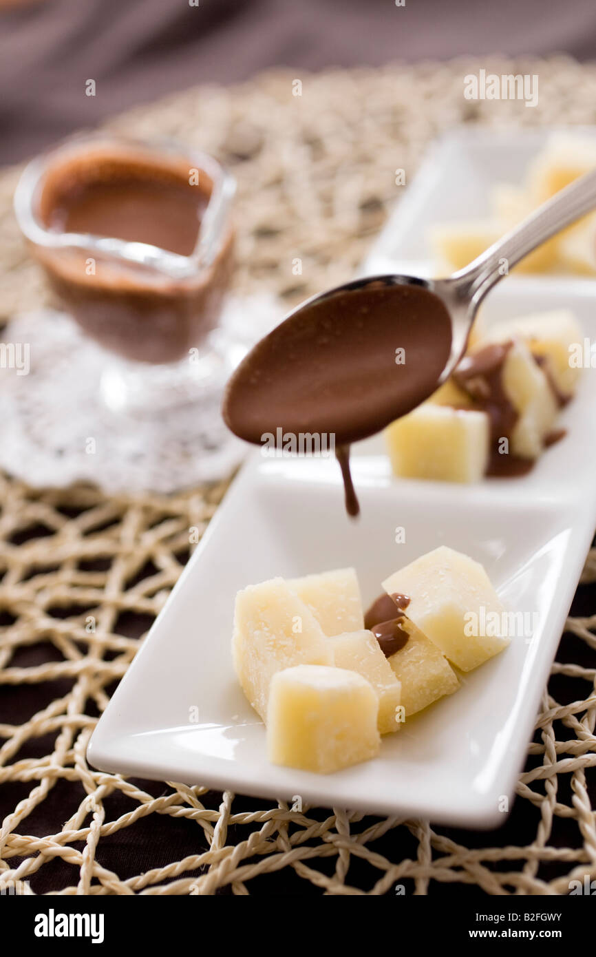 Cheese cubes and melted chocolate Stock Photo - Alamy