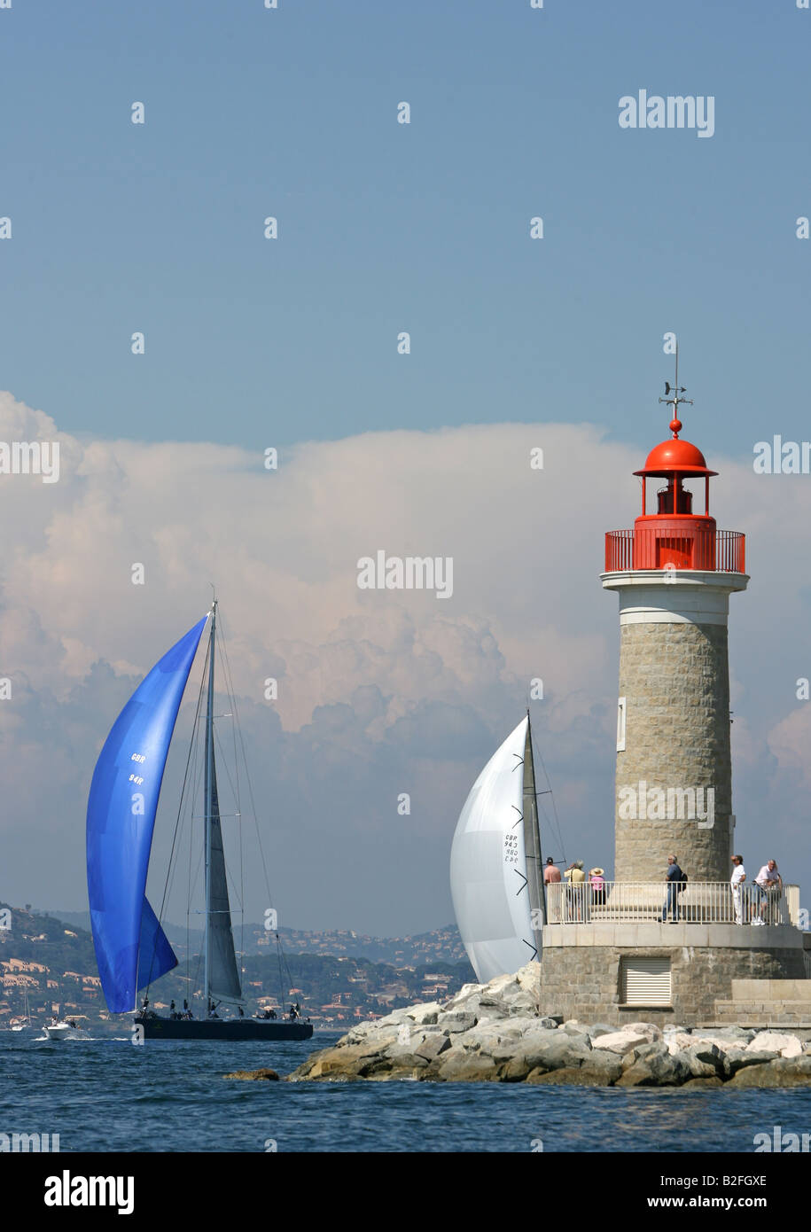 Racing yachts pass a lighthouse Stock Photo - Alamy