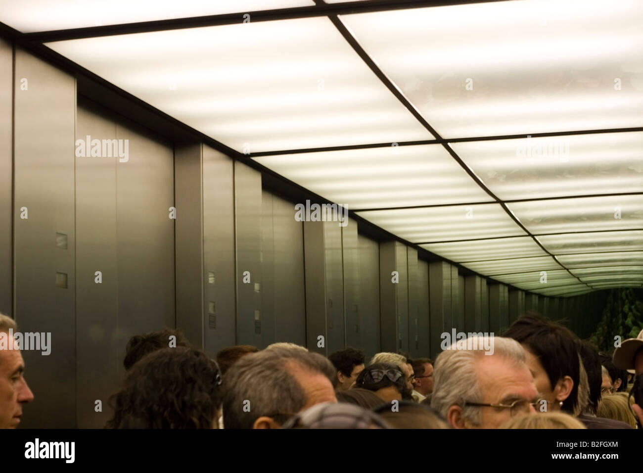 Crowd in illuminated lift, elevator Stock Photo - Alamy