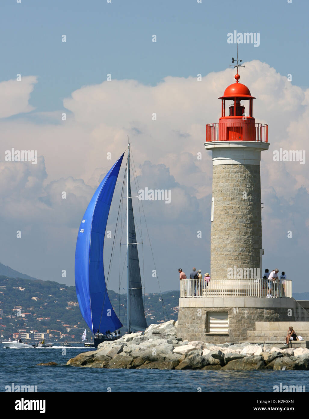 A racing yacht passes a lighthouse Stock Photo - Alamy
