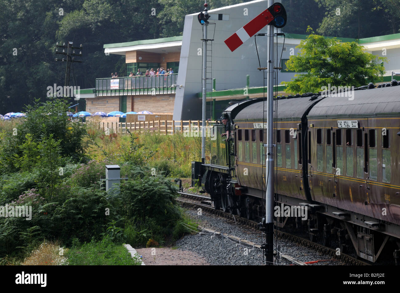 Steam train leaving Highley station past the engine house on the Severn ...