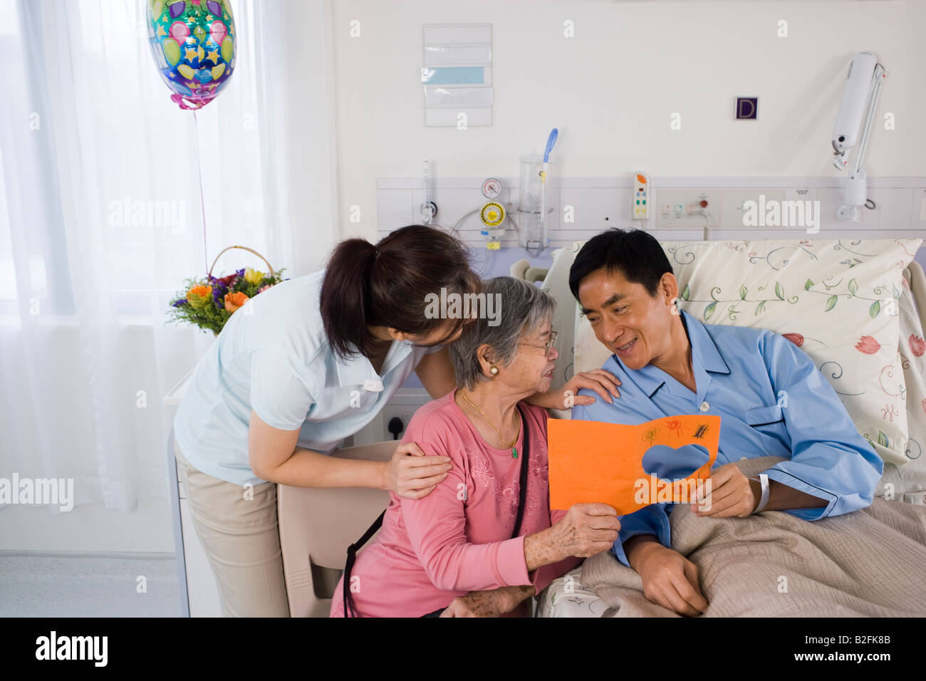 Male patient holding a Get Well card with his family Stock Photo - Alamy