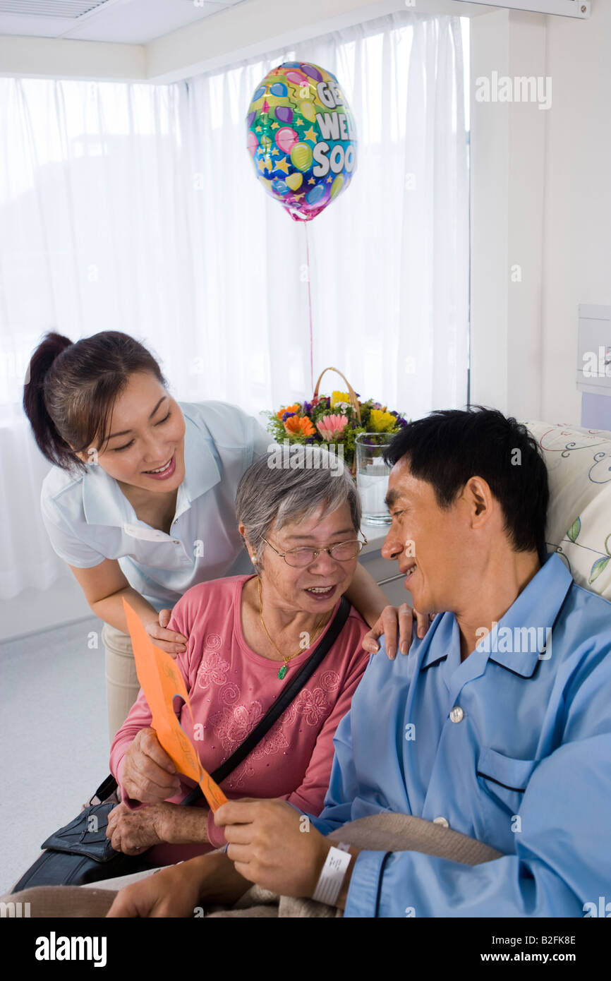 Male patient reading a Get Well card with his family Stock Photo - Alamy