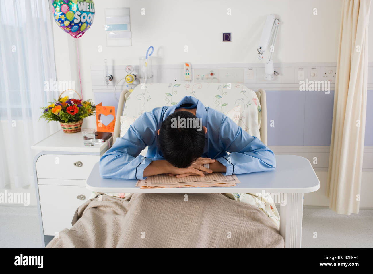 Patient resting his head on his hands in a hospital room Stock Photo ...
