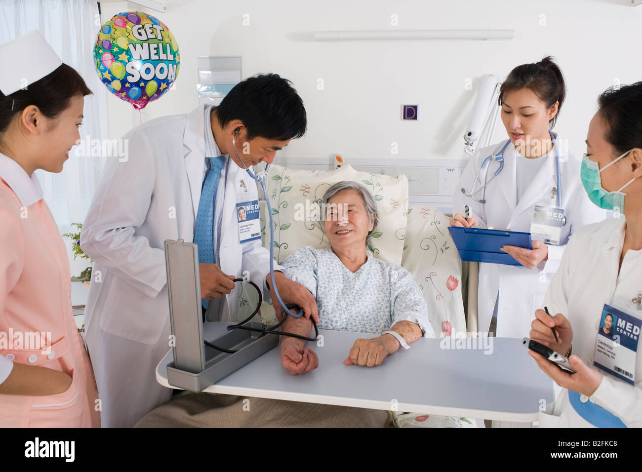Two doctors and two nurses examining a female patient Stock Photo - Alamy