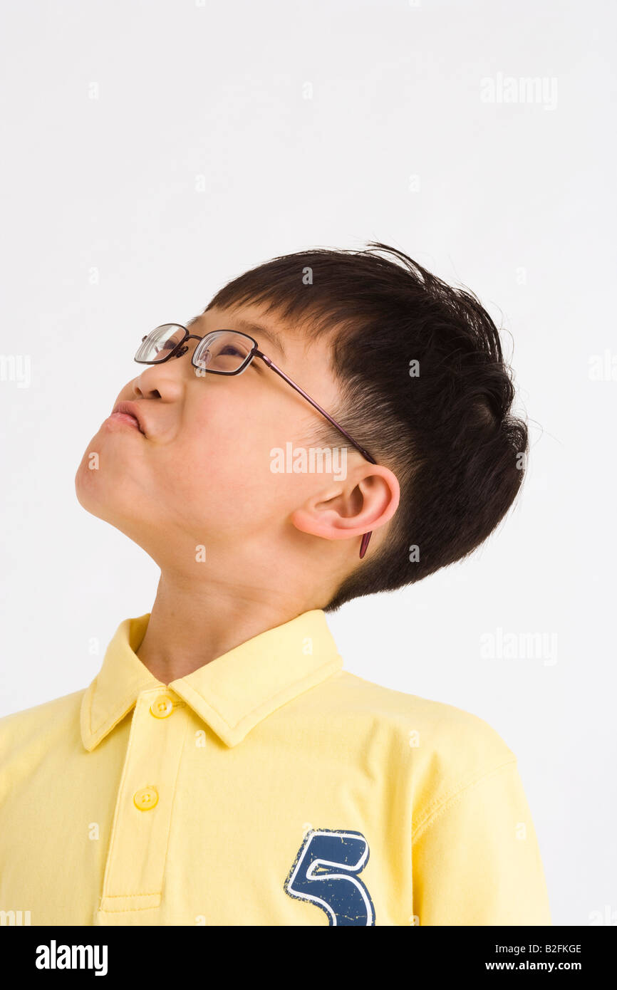 Close-up of a boy looking up and making a face Stock Photo - Alamy