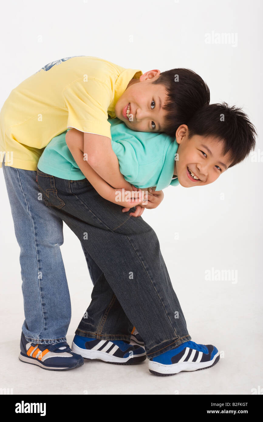 Portrait of a boy play fighting with his brother Stock Photo - Alamy