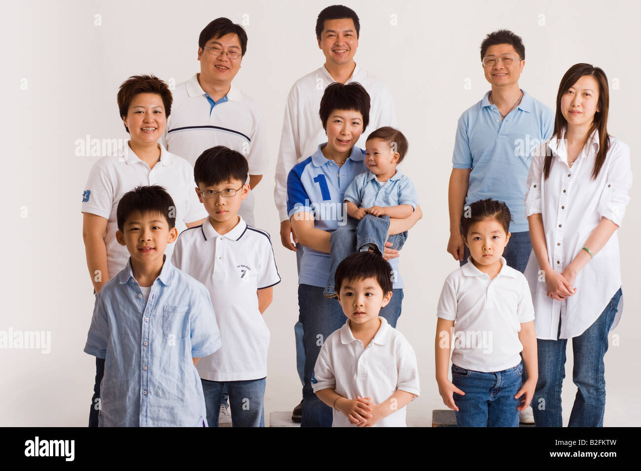 Portrait of three mid adult couples with their children Stock Photo - Alamy