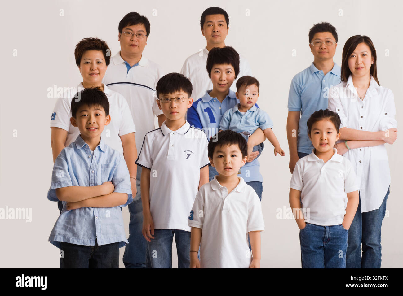 Portrait of three mid adult couples with their children Stock Photo - Alamy