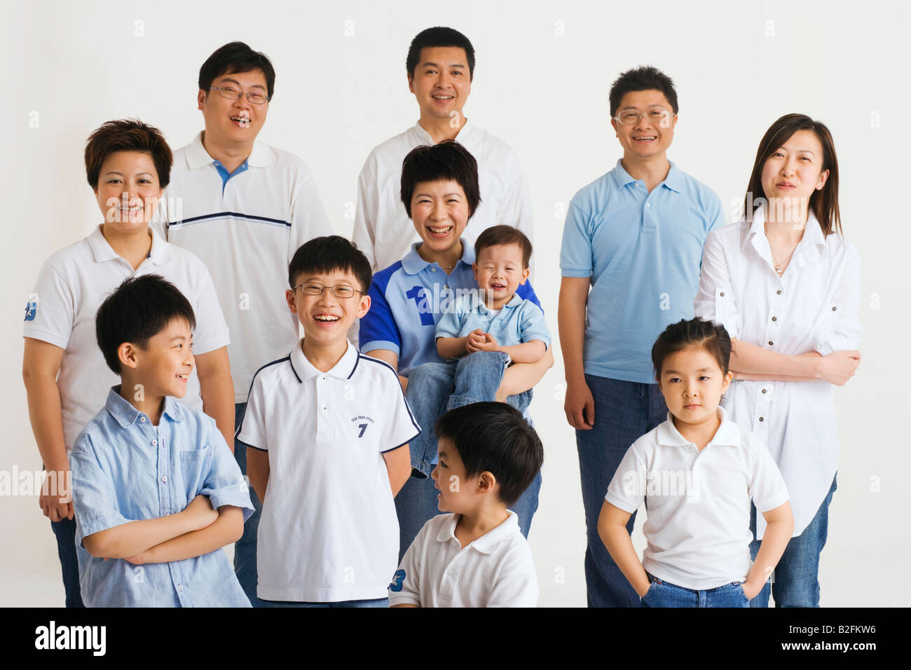 Portrait of three mid adult couples with their children Stock Photo - Alamy