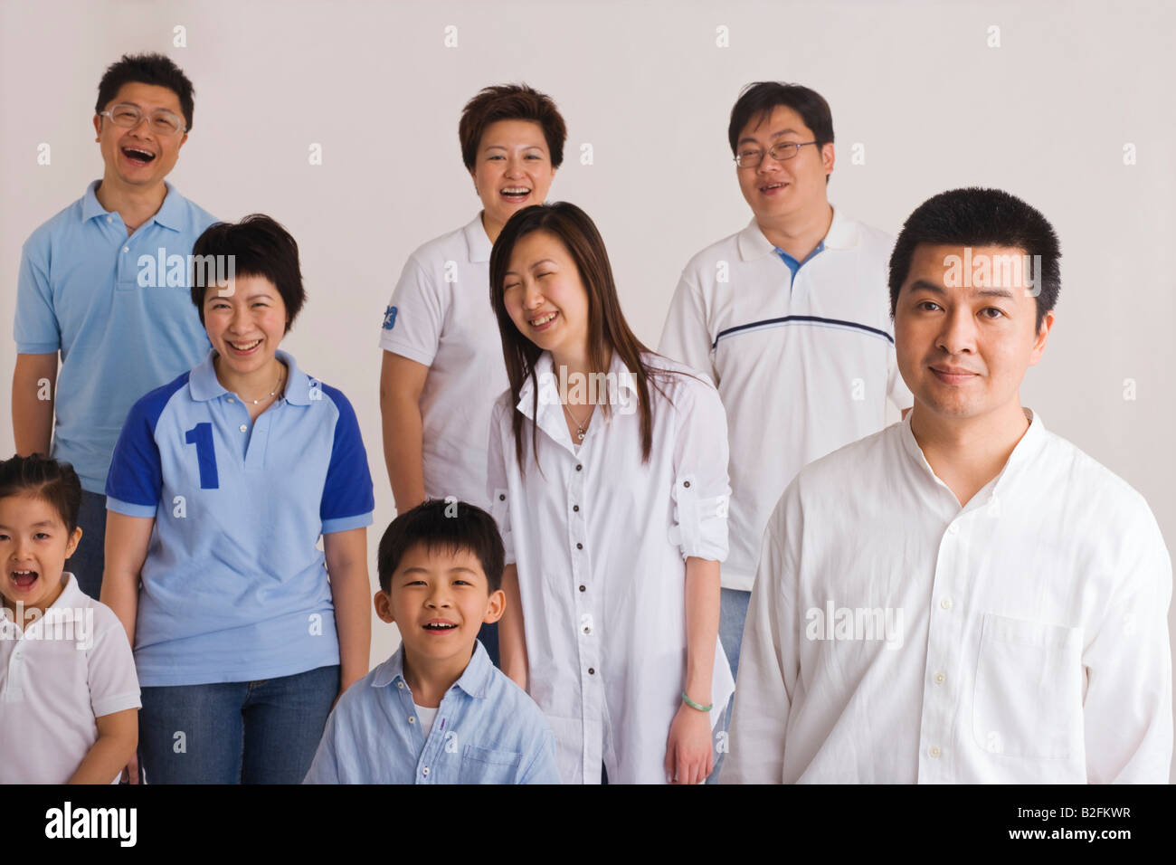 Portrait of three mid adult couples with their children Stock Photo - Alamy