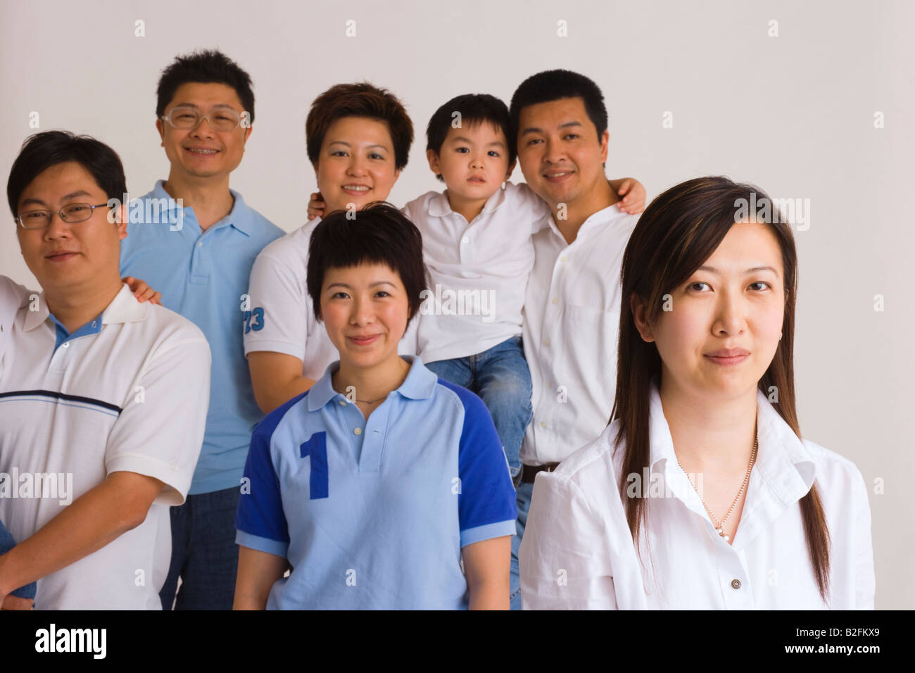 Portrait of three mid adult couples with their children Stock Photo - Alamy