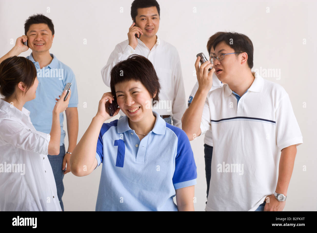 Five people talking on mobile phones Stock Photo - Alamy