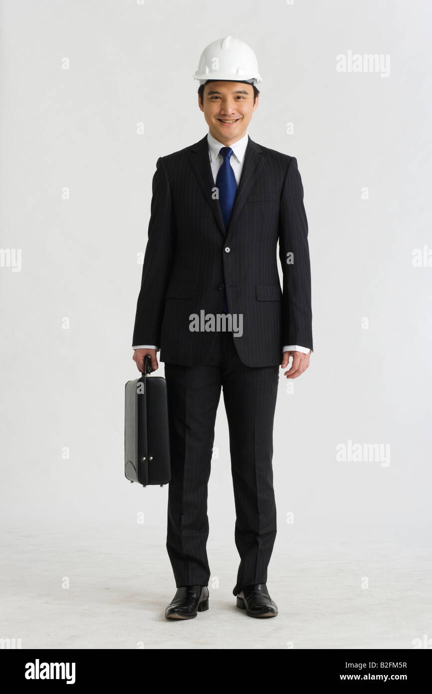 Portrait of a male architect carrying a briefcase and smiling Stock ...