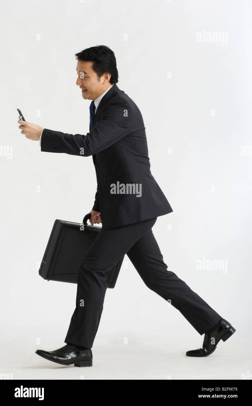 Side profile of a businessman carrying a briefcase Stock Photo - Alamy