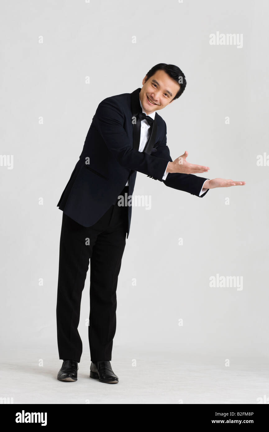 Portrait of a waiter greeting and smiling Stock Photo - Alamy