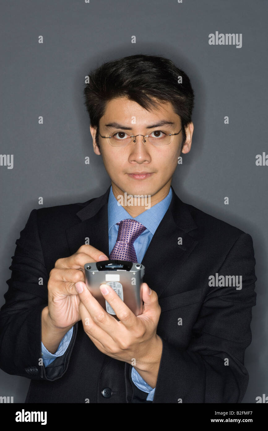 Portrait of a businessman using a personal data assistant Stock Photo ...