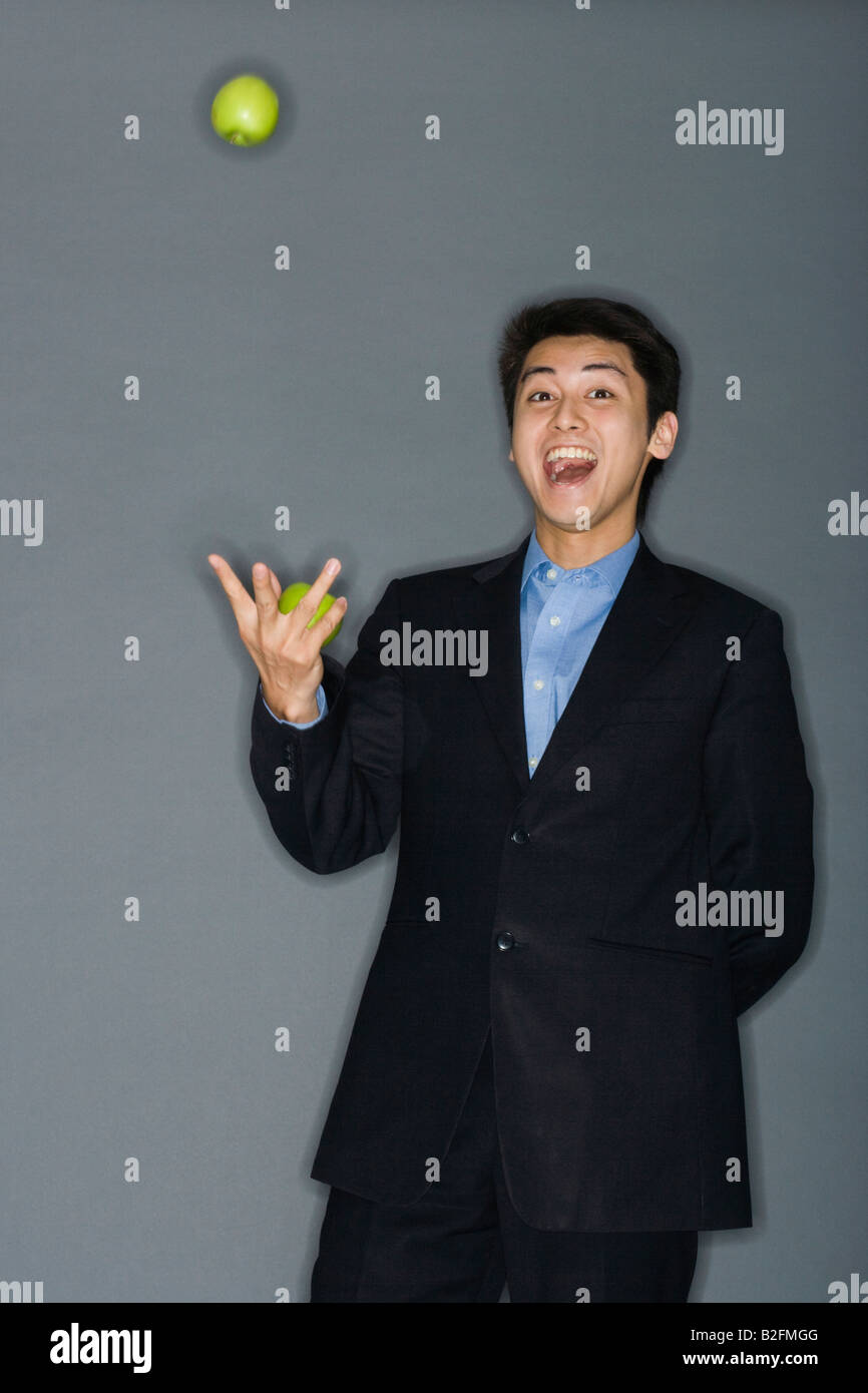 Portrait of a businessman juggling apples Stock Photo - Alamy