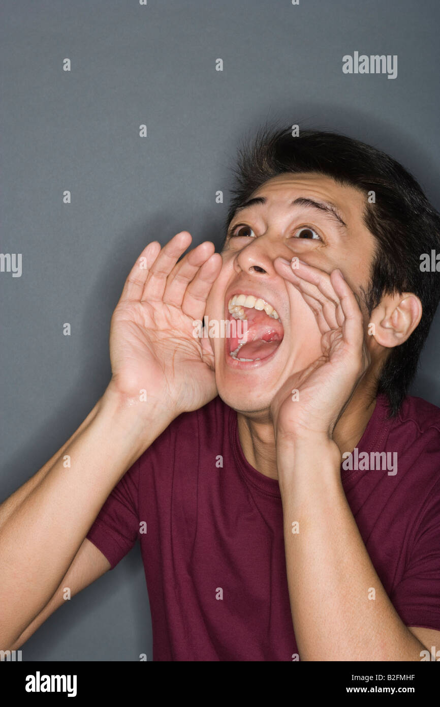 Close-up of a young man screaming Stock Photo - Alamy