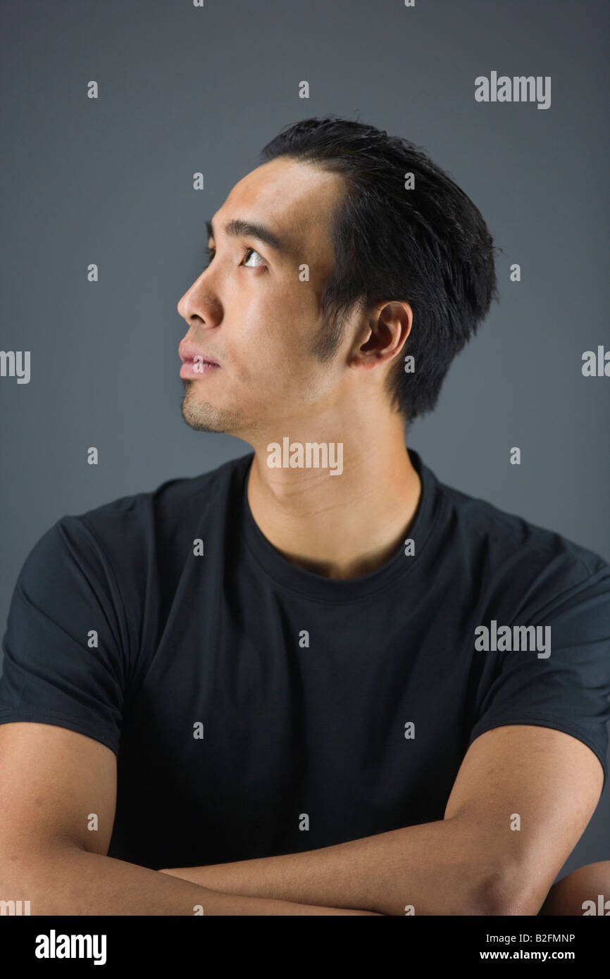 Close-up of a young man thinking Stock Photo - Alamy