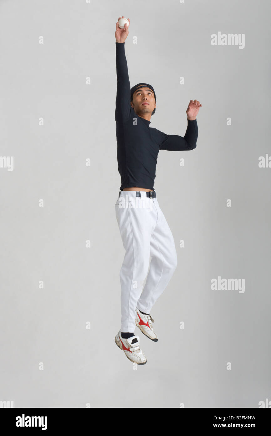 Baseball player holding out baseball hi-res stock photography and ...