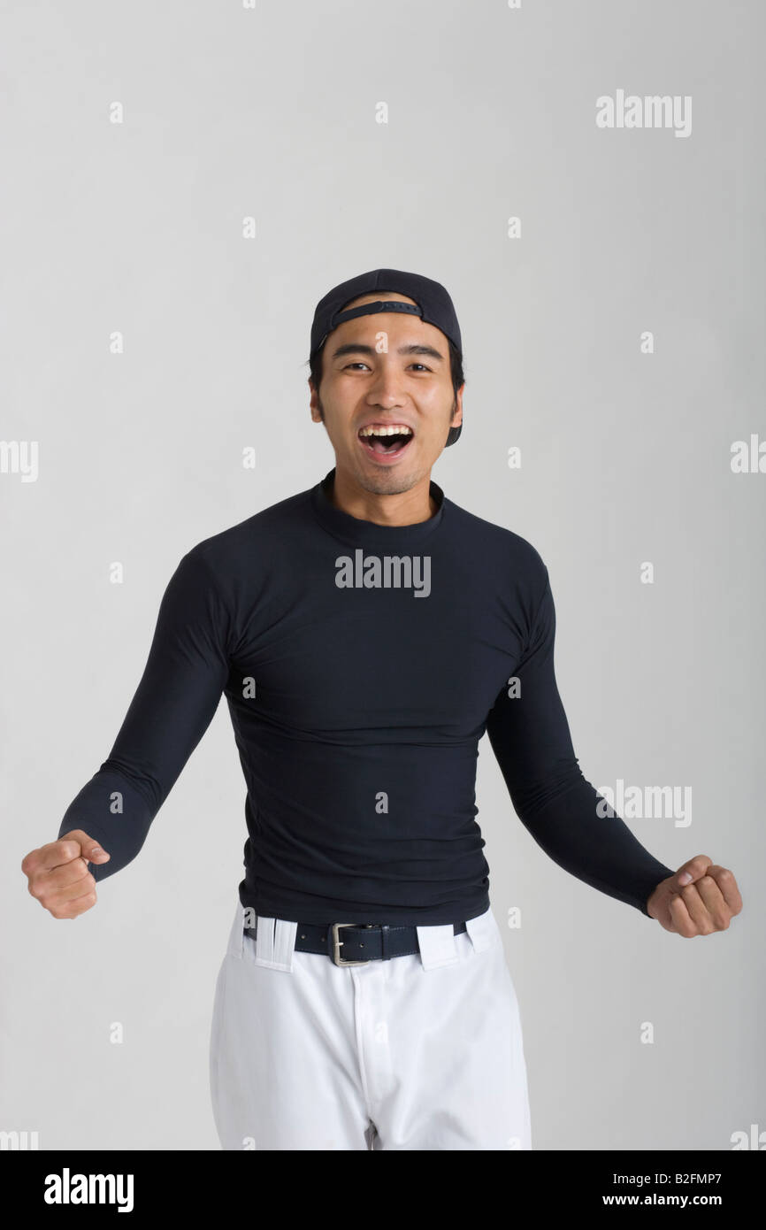 Portrait of a young man standing and smiling Stock Photo - Alamy