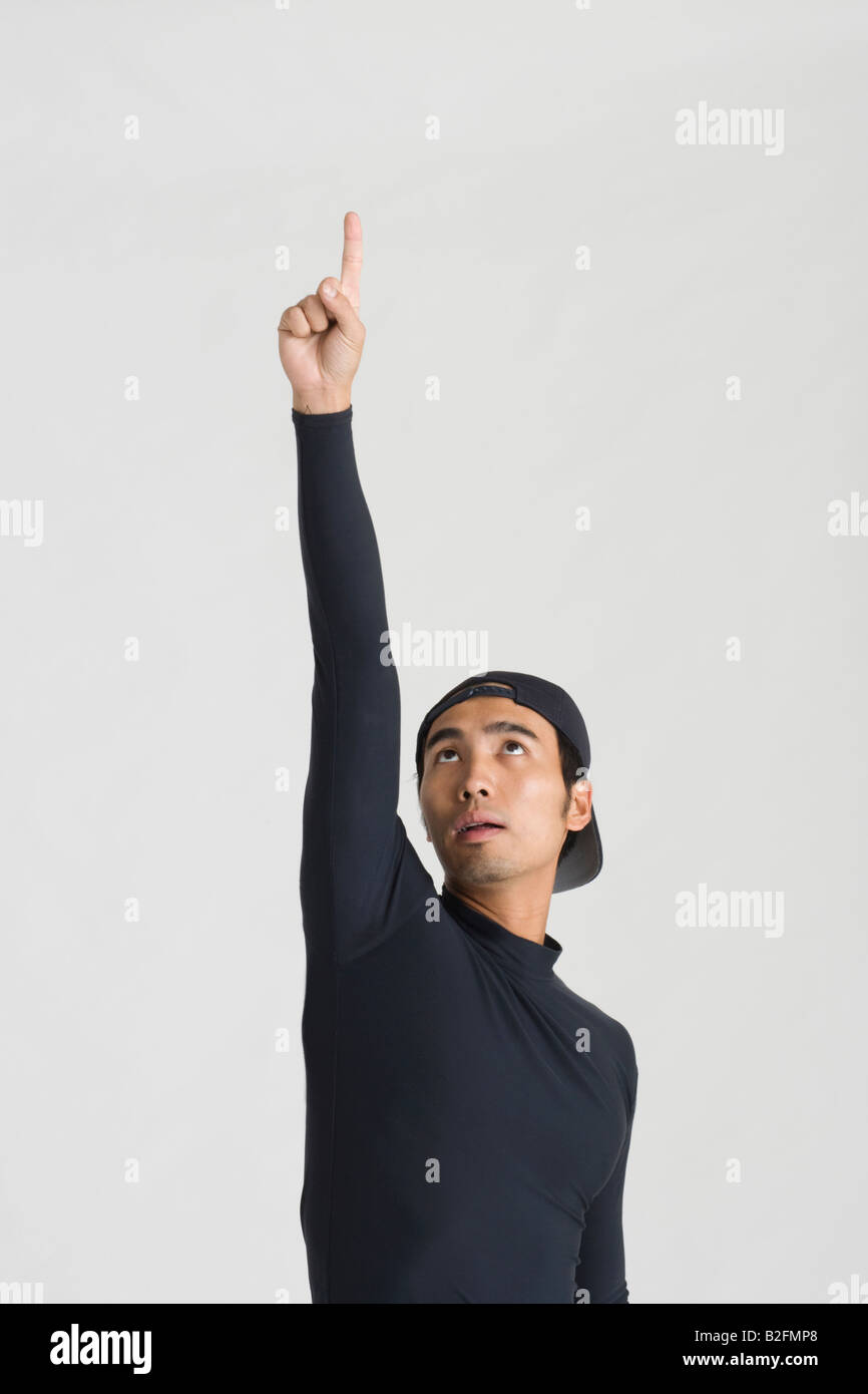Young man standing and pointing Stock Photo - Alamy