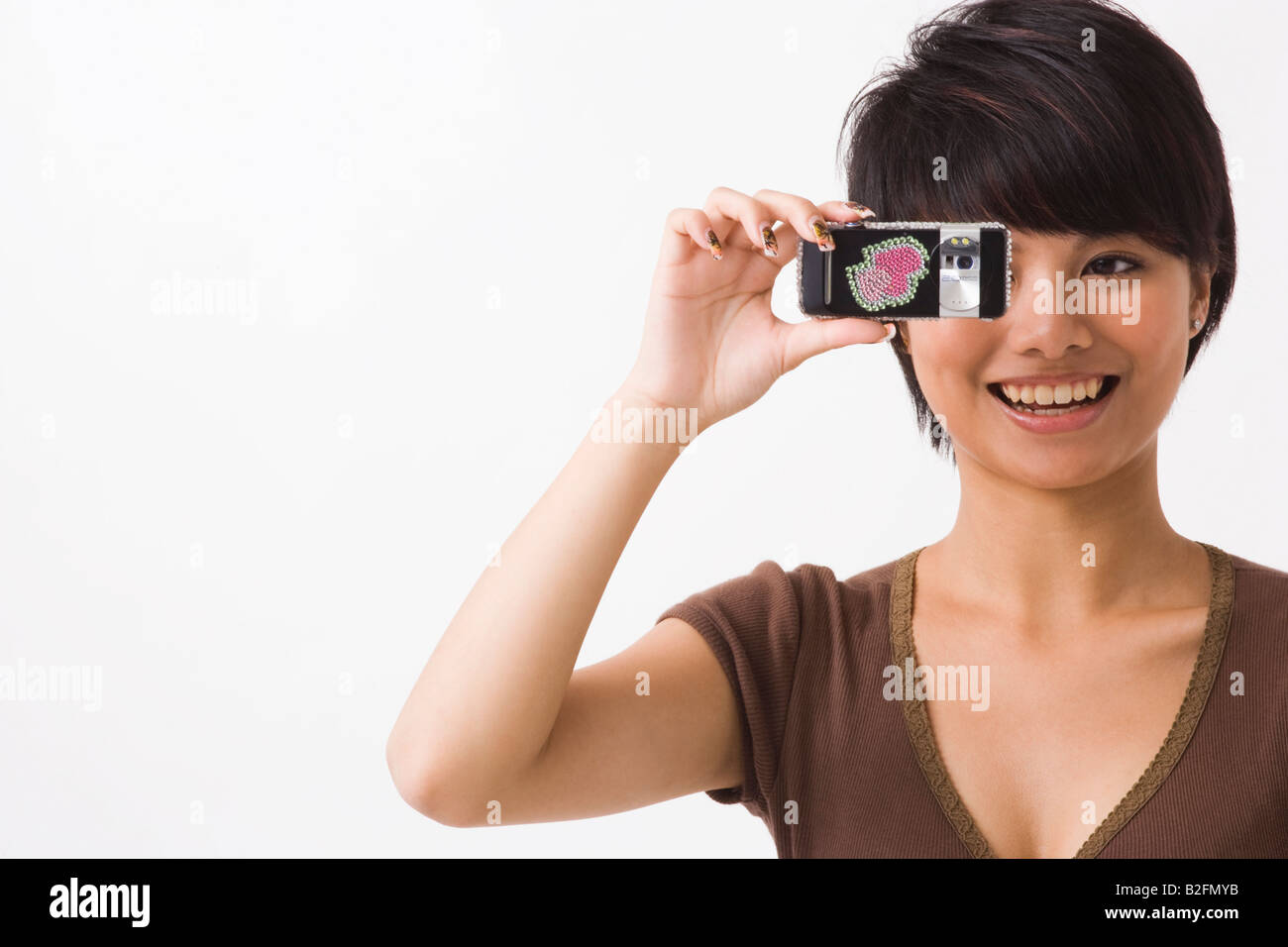 Young woman photographing with a camera phone Stock Photo - Alamy